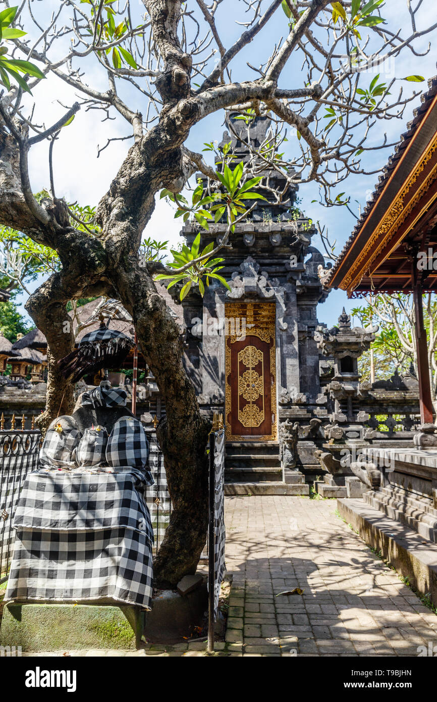 Ancient megaliths in black and white Saput Poleng cloths at altars at ...