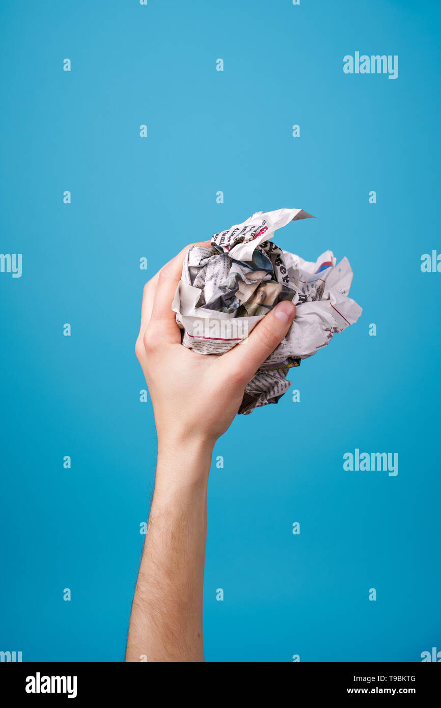 hand with crumpled newspaper Stock Photo - Alamy