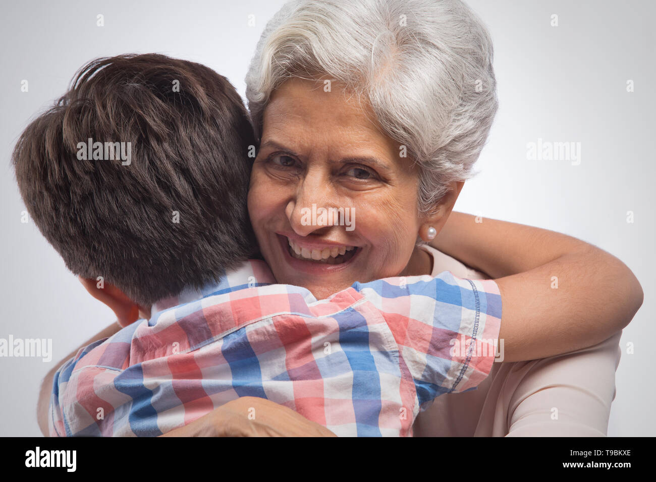 Grandmother hugging her grandson Stock Photo - Alamy