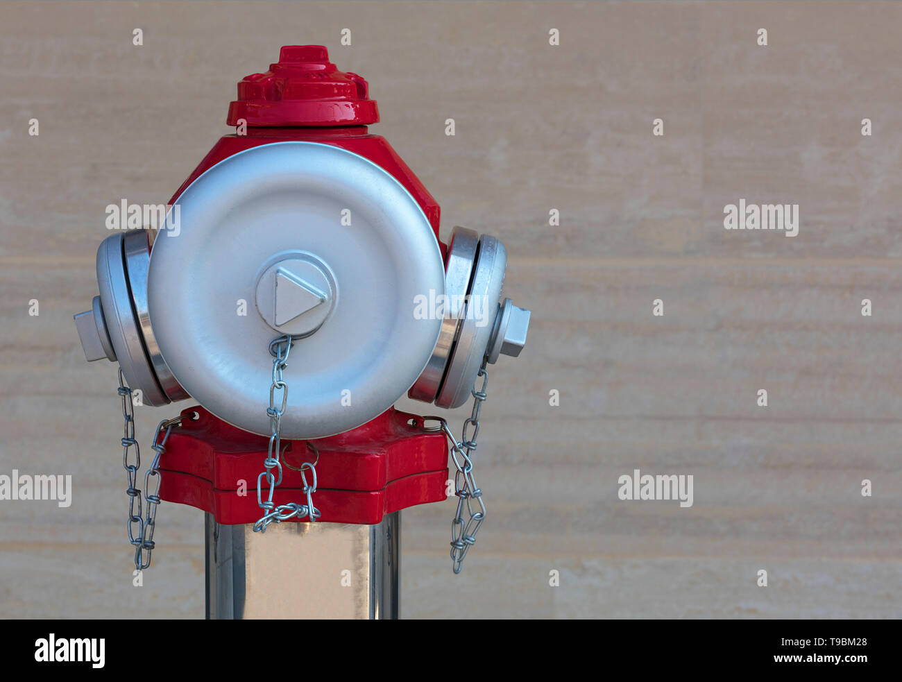 The head of the fire red hydrant with frosted steel caps on the ...