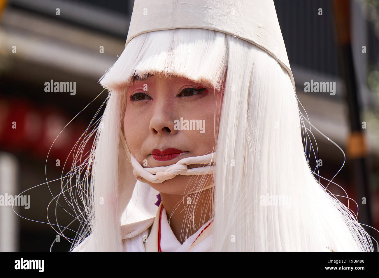 Young Japanese woman dressed as egret (白鷺, shirasagi) with white wig for a traditional dance ...