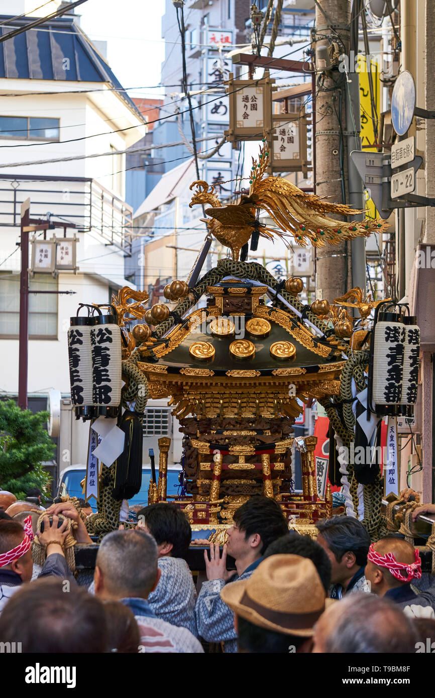 Japanese men carry or hoist up a mikoshi (omikoshi, portable shrine) on ...