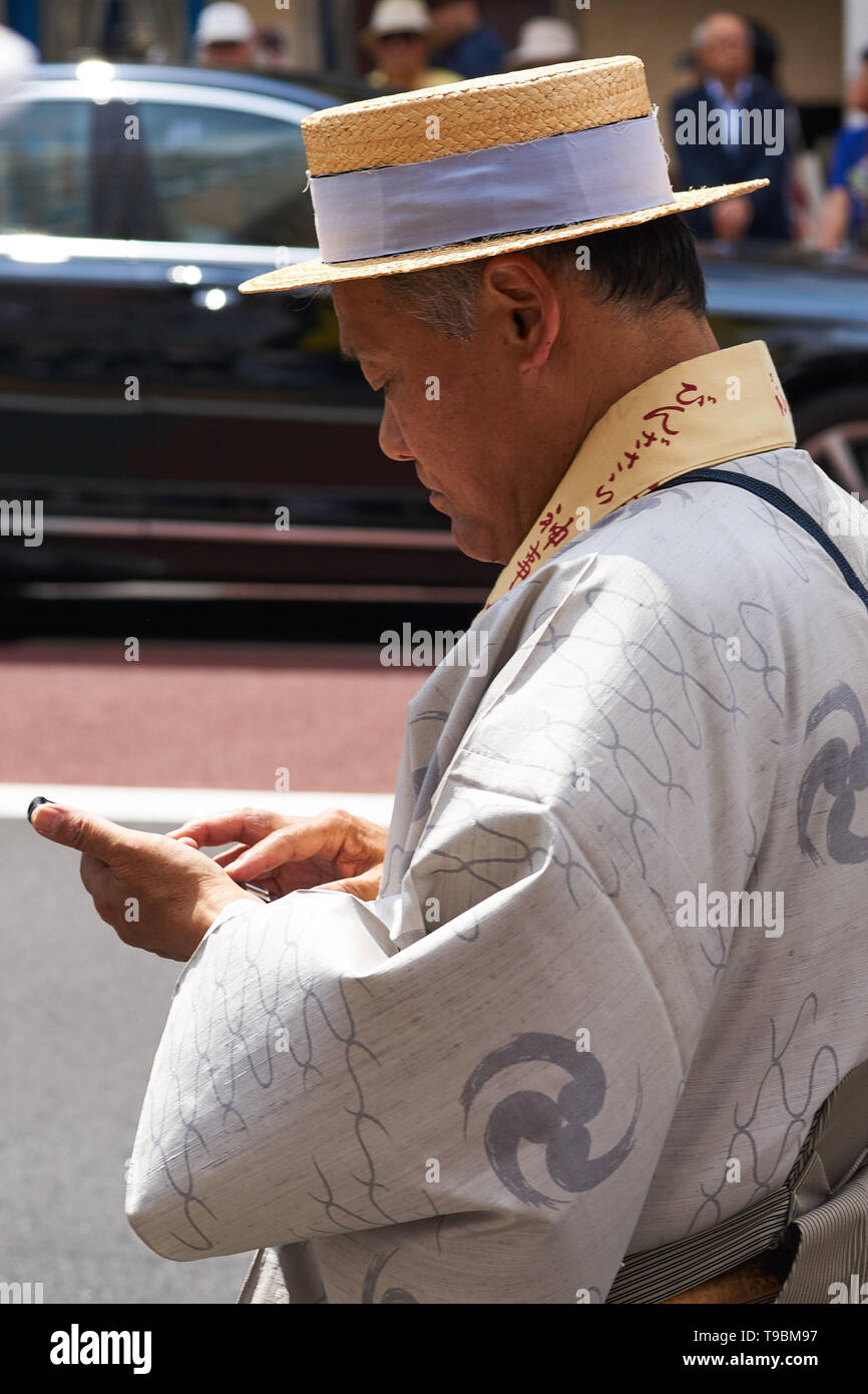 Japanese man dressed in yukata and straw hat with purple band ...