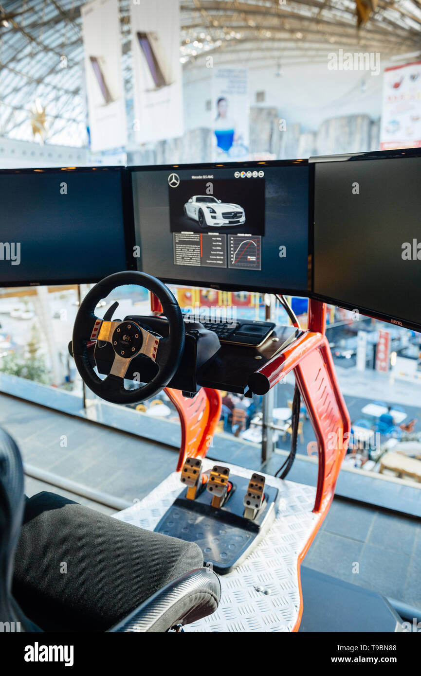 Bucharest, Romania - 2016: Side view of triple screen setup with ...