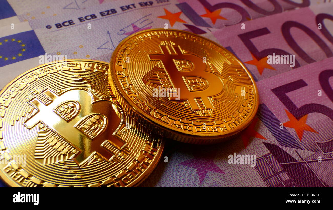 Golden physical coin bitcoin on euro banknotes hi-res stock photography ...
