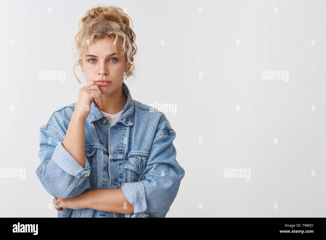 Serious-looking thoughtful focused creative female designer thinking ...