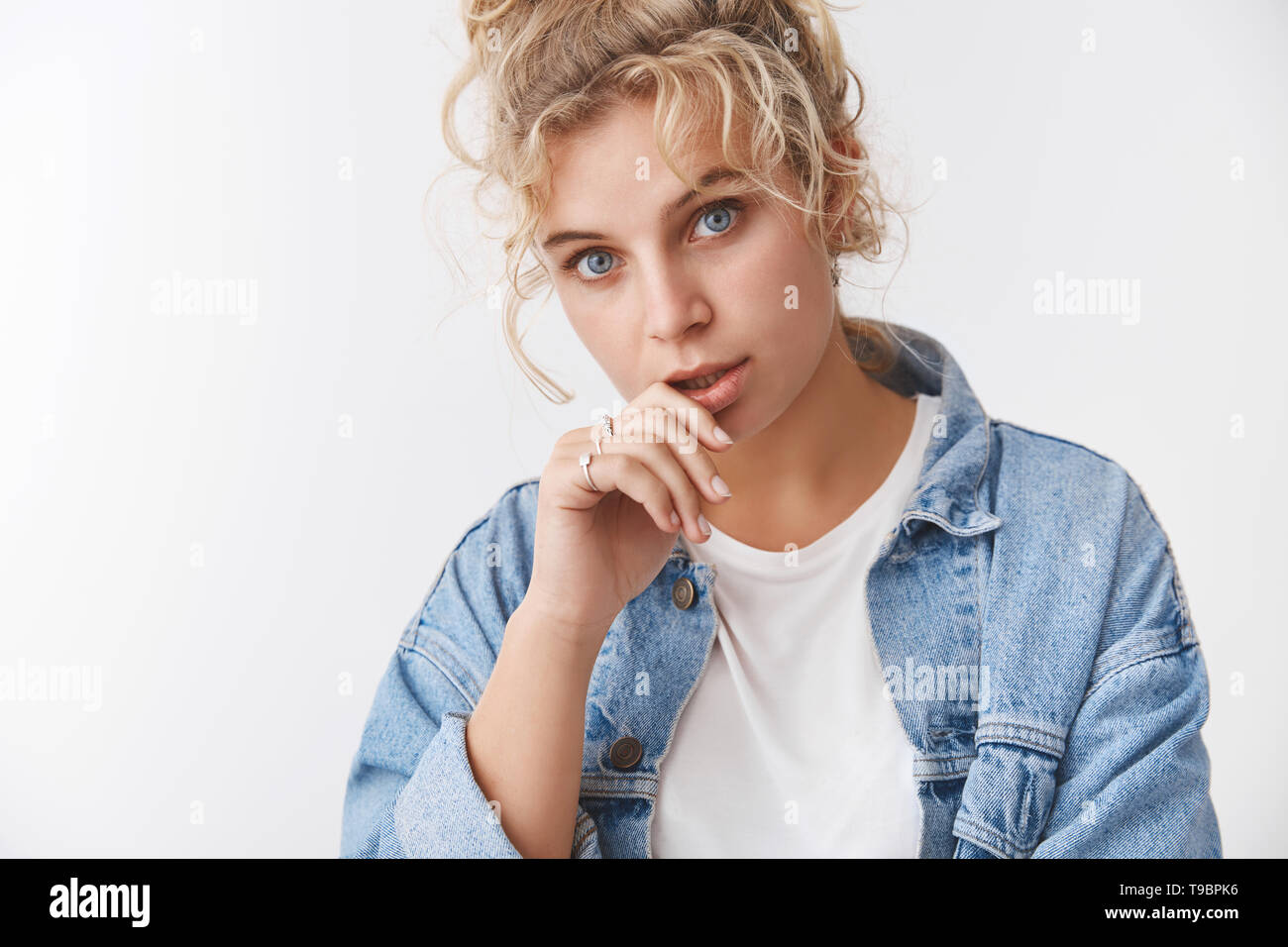 Stylish millennial attractive sassy blond curly-haired girl blue eyes ...