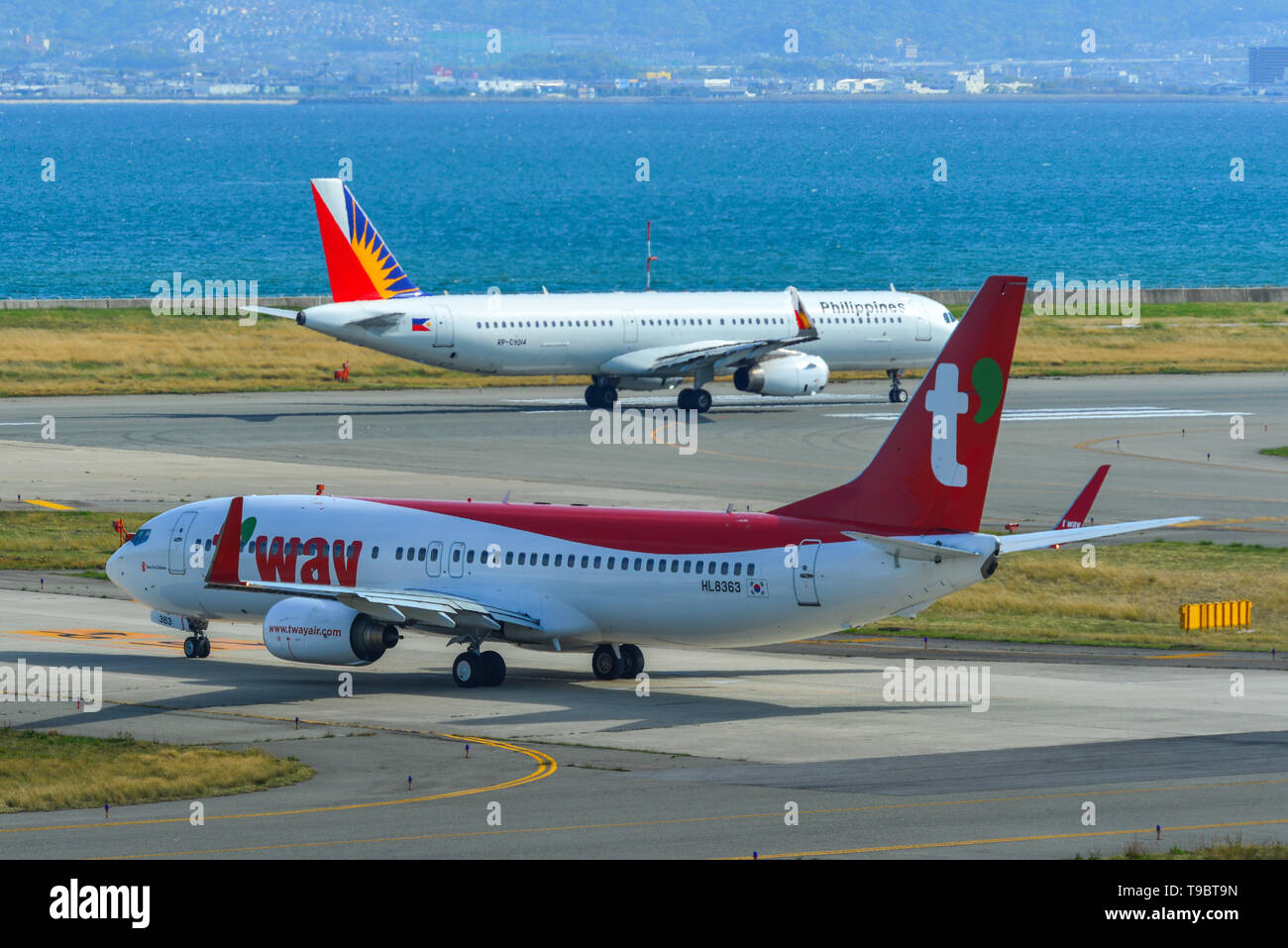 Osaka, Japan - Apr 19, 2019. Passenger airplanes taxiing on runway of ...