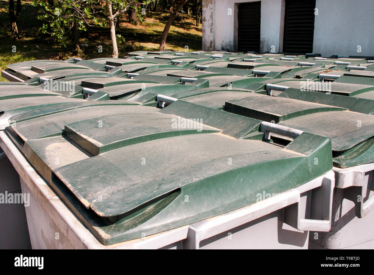Large garbage containers, trash dumpsters and bins standing in row ...