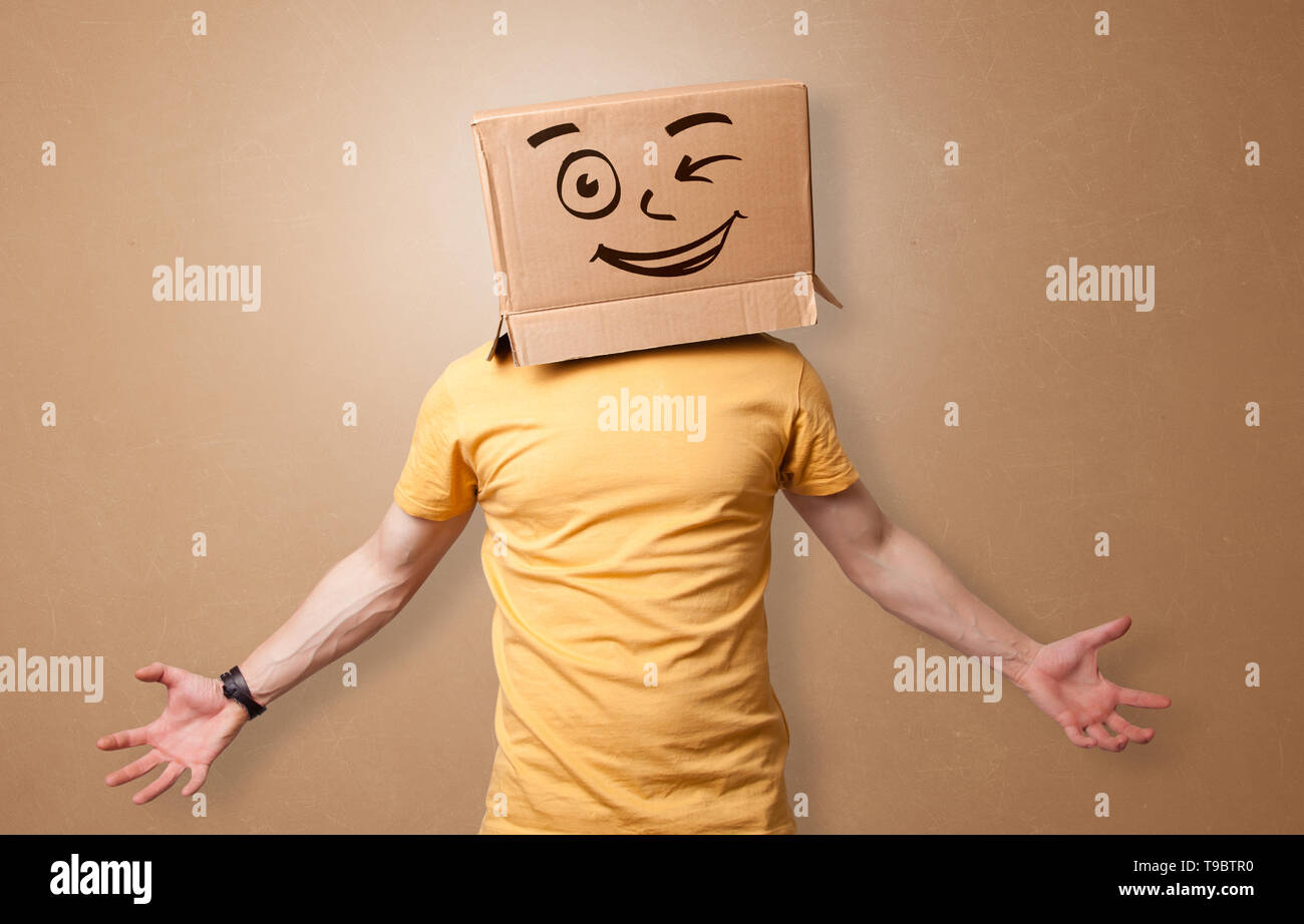 Handsome man standing and gesturing with a carton box on his head Stock ...
