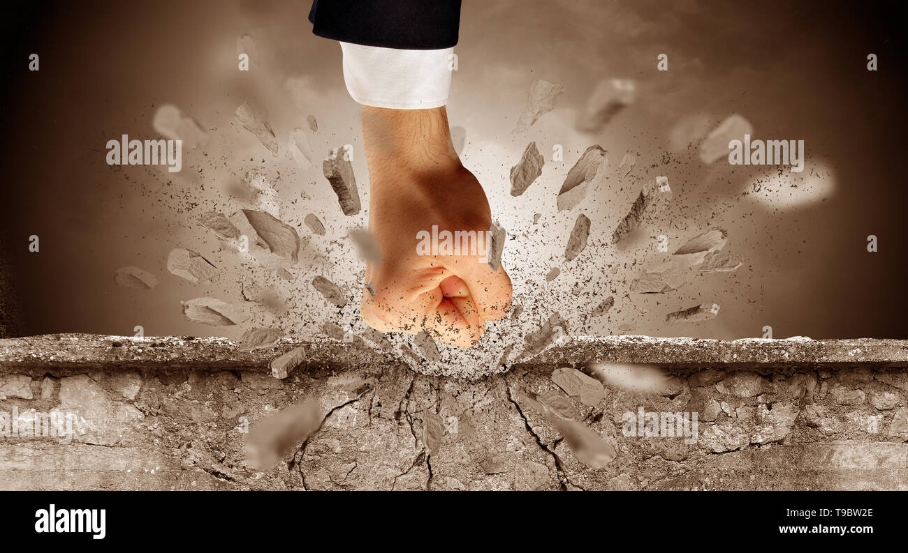 Big hand hits intense and breaks a crass stonewall Stock Photo - Alamy
