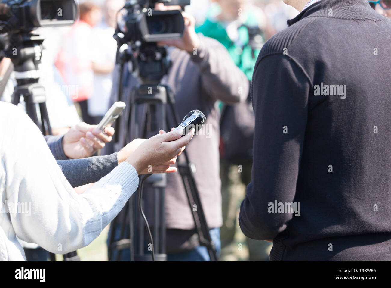 Filming news conference with a video camera. Video coverage of a media ...