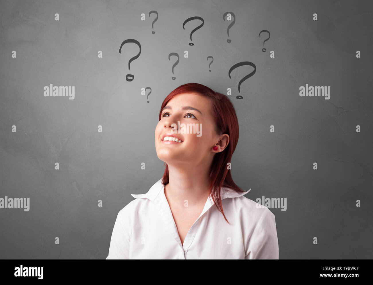 Person with question marks around face Stock Photo - Alamy