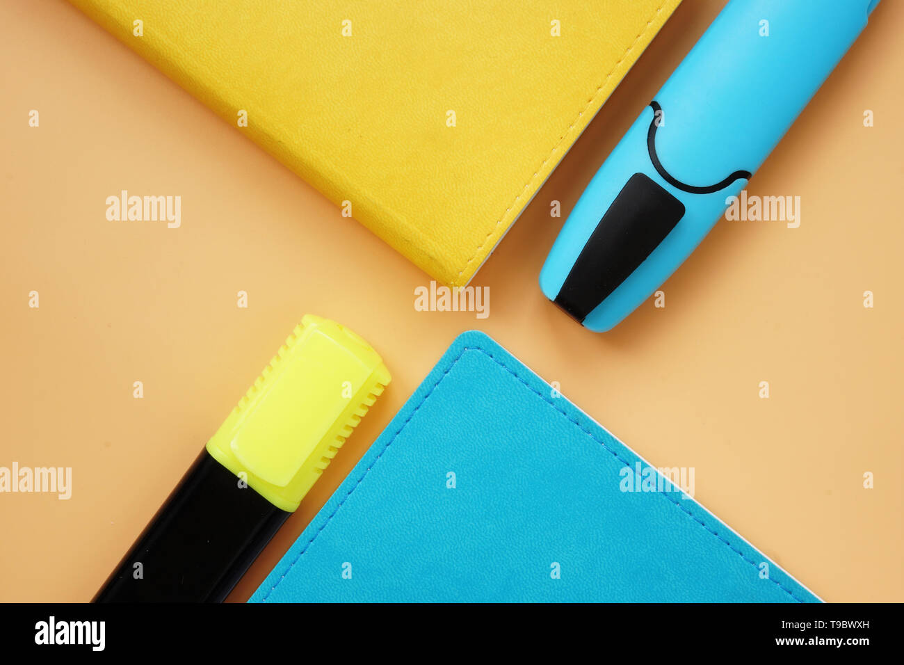 Colorful notepads and pens on desk. Top view Stock Photo - Alamy
