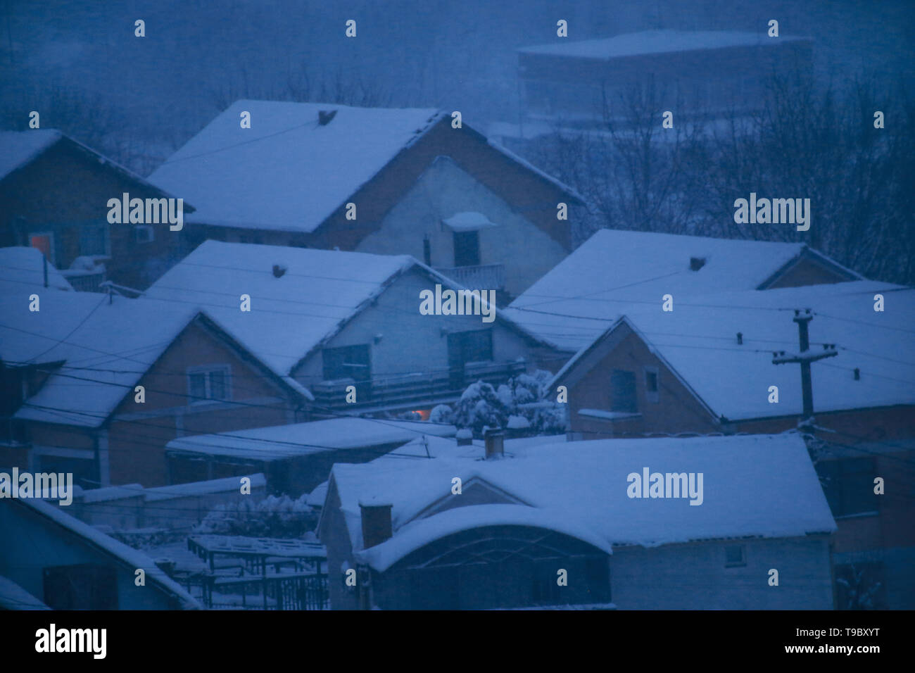Beautiful winter view of houses and buildings with roofs covered with ...
