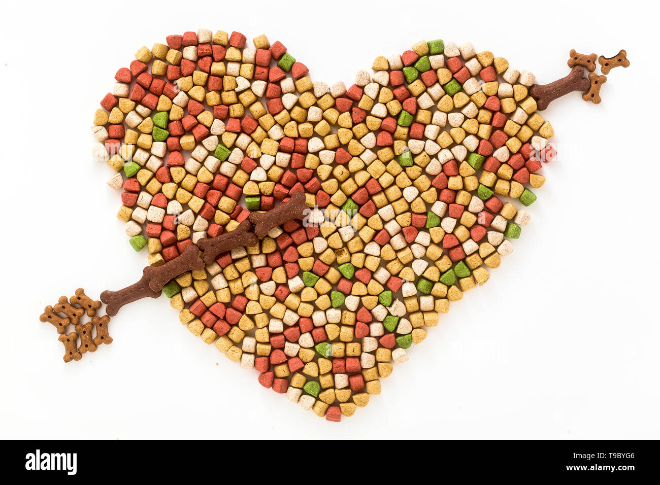 dry pet food in the shape of a heart shape isolated on white background ...