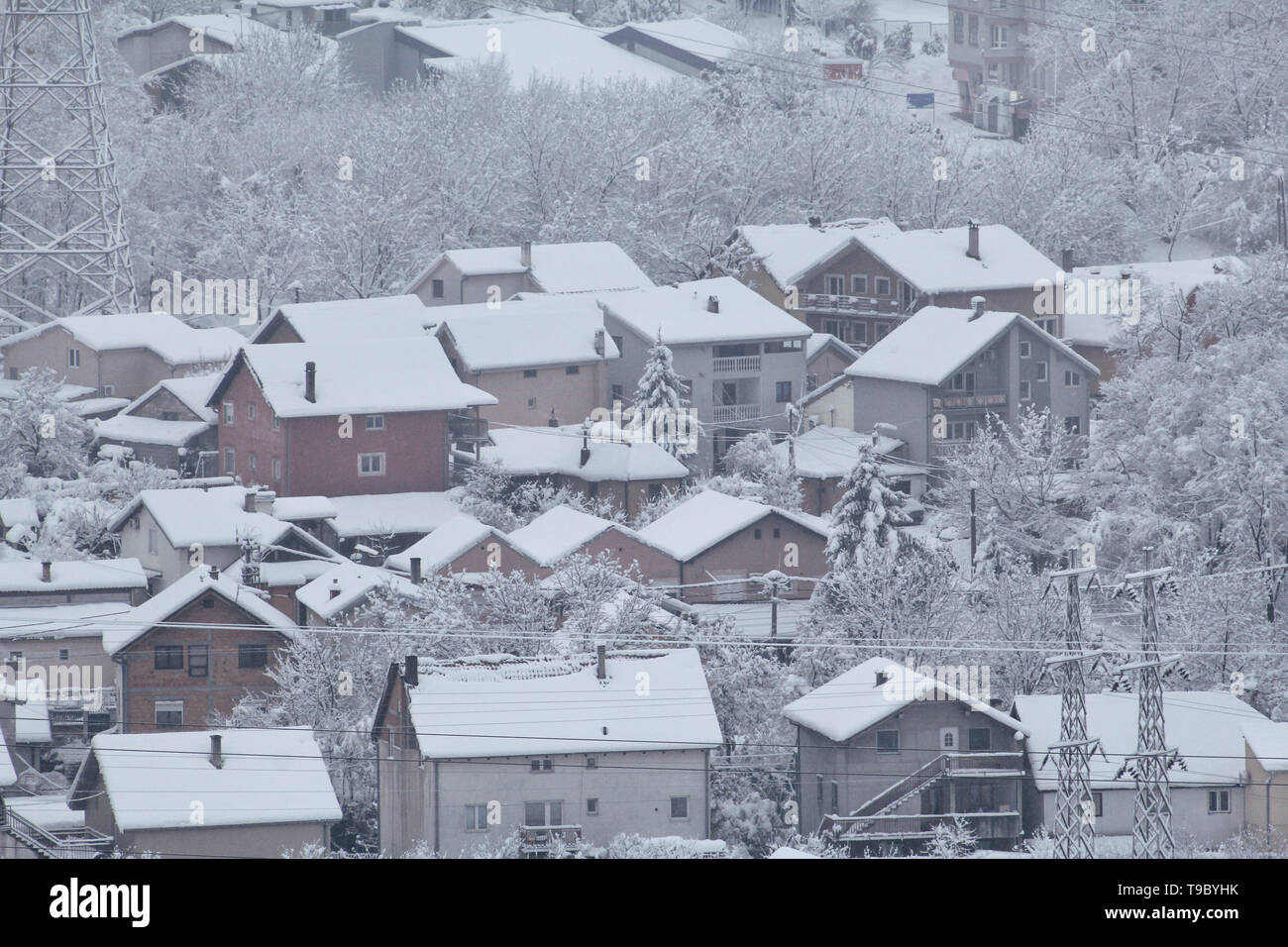 Beautiful winter view of houses and buildings with roofs covered with ...