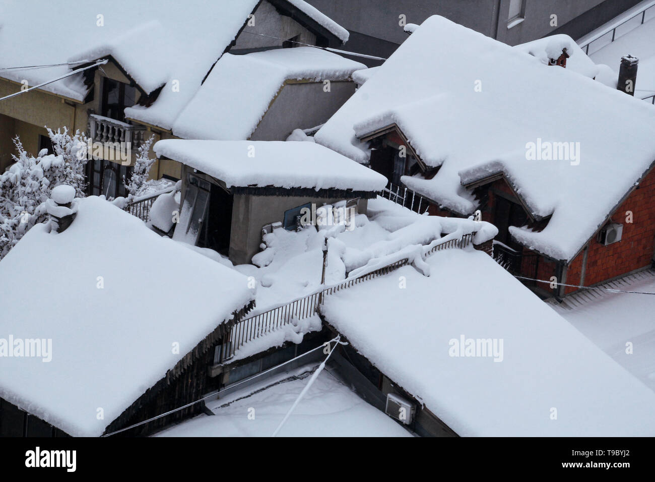 Beautiful winter view of houses and buildings with roofs covered with ...
