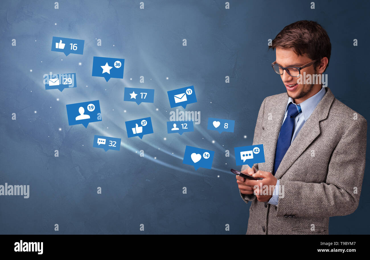 Young person using phone with flying social media icons around Stock ...