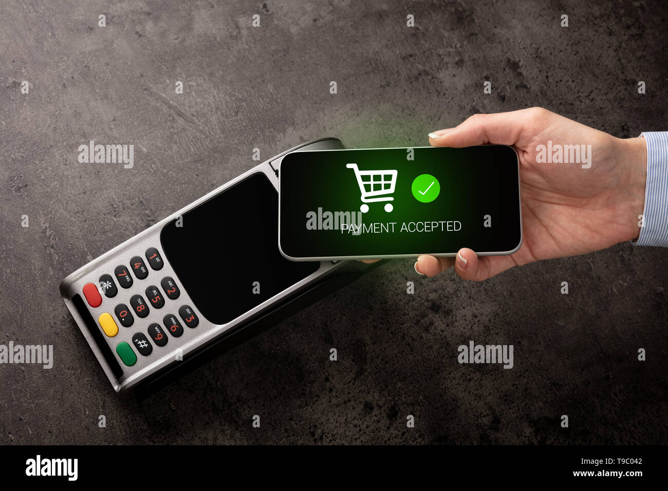 Mobile payment accepted on terminal Stock Photo - Alamy