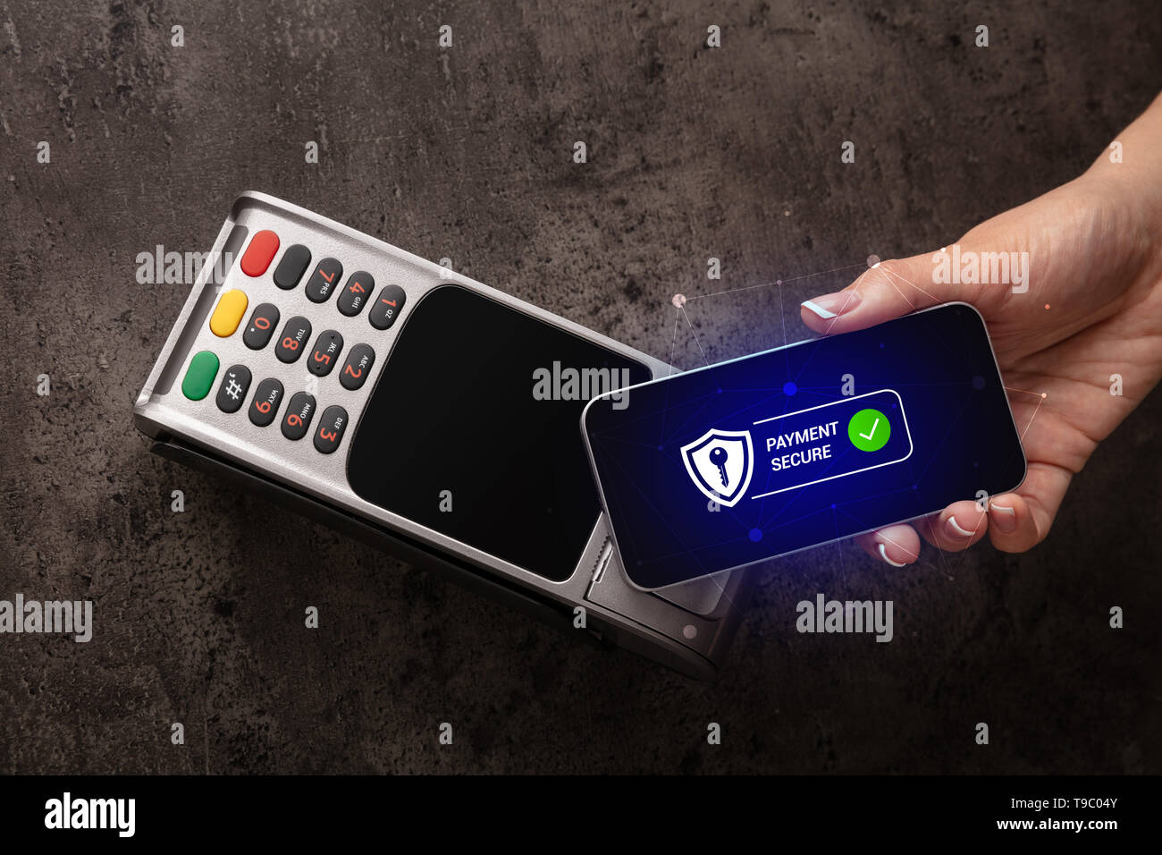 Hand paying on terminal with smartphone in secure payment system Stock ...