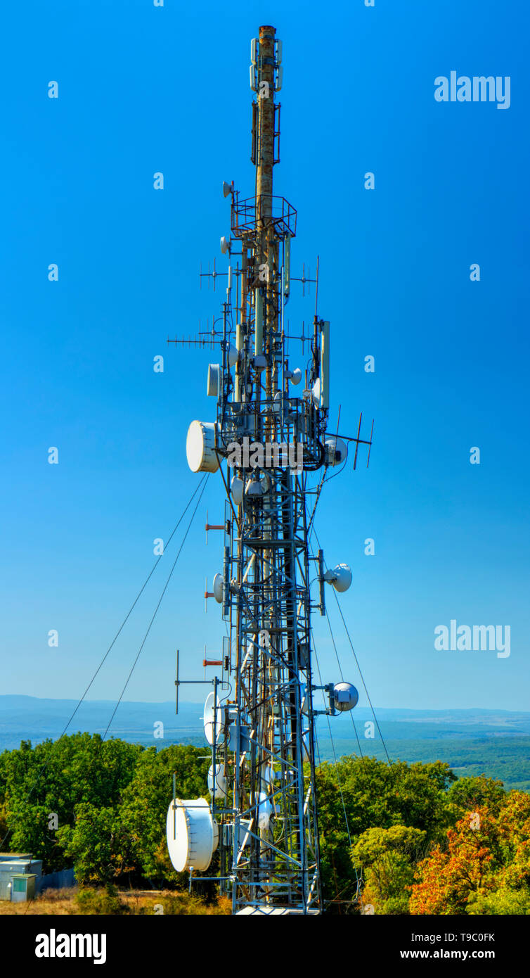 Communication antenna tower on blue sky Stock Photo - Alamy