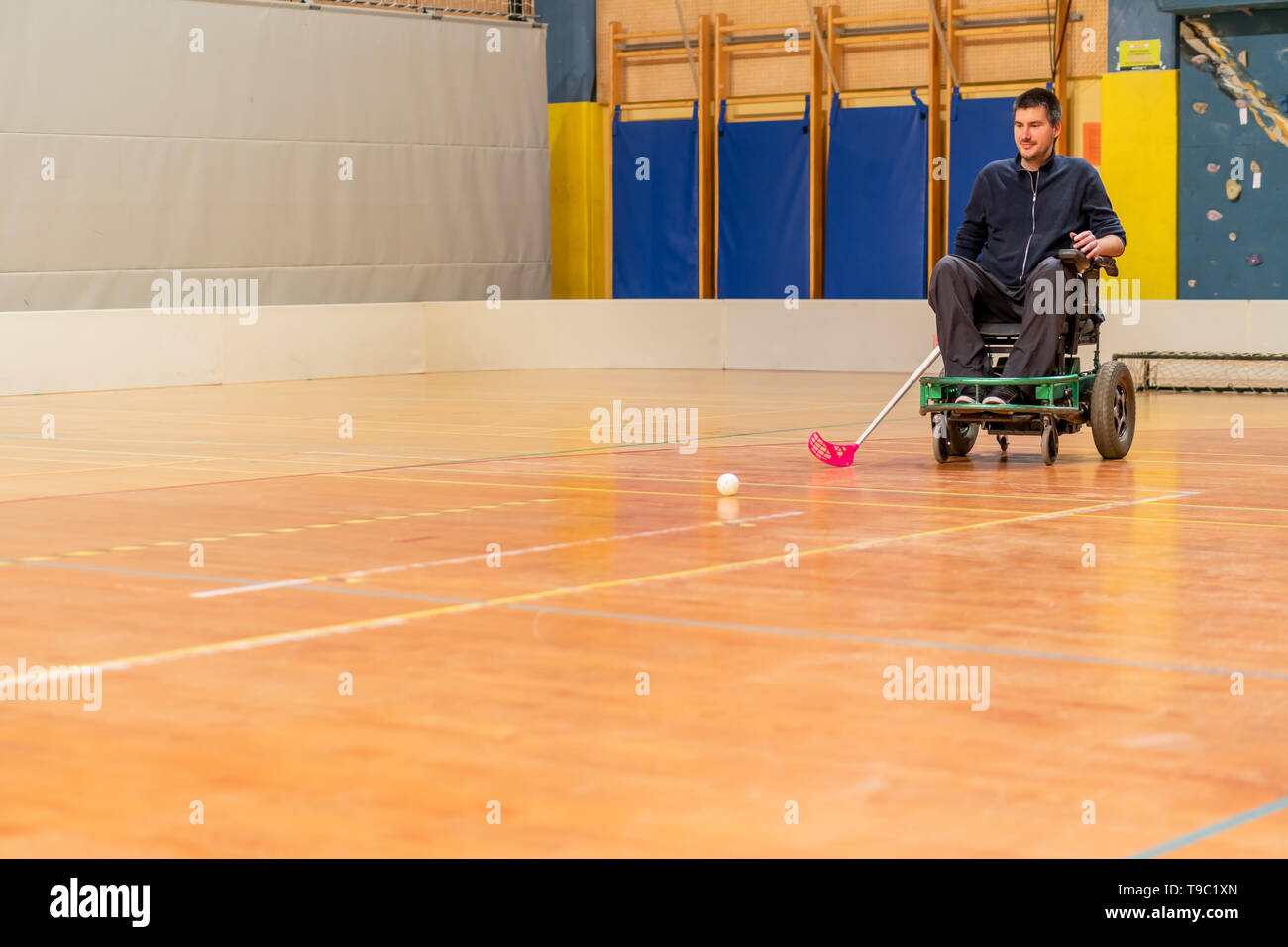 Disabled man on an electric wheelchair playing sports, powerchair ...