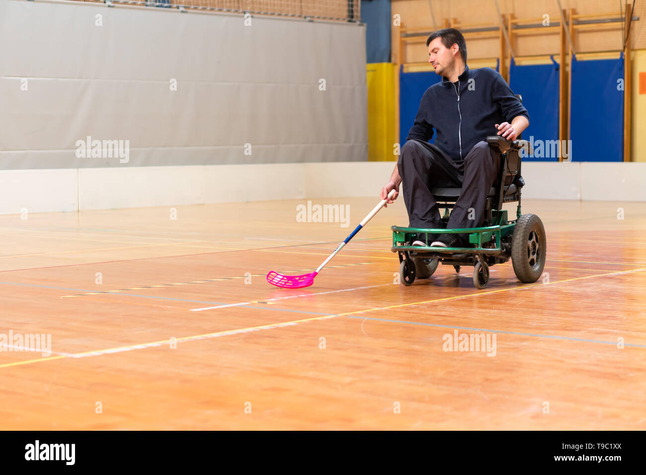 Disabled man on an electric wheelchair playing sports, powerchair ...