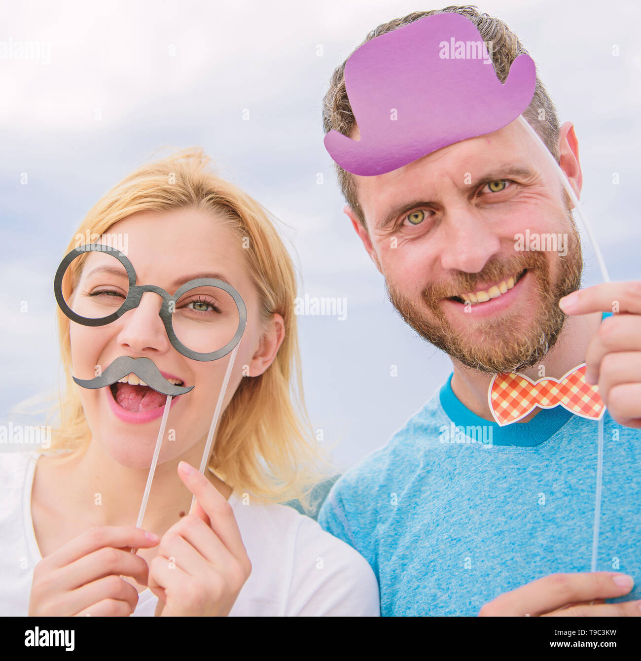 Couple posing with party props sky background. Humor and laugh concept ...