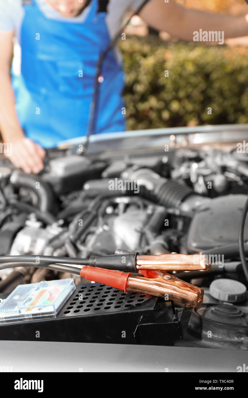 Battery charger under open hood of car Stock Photo - Alamy