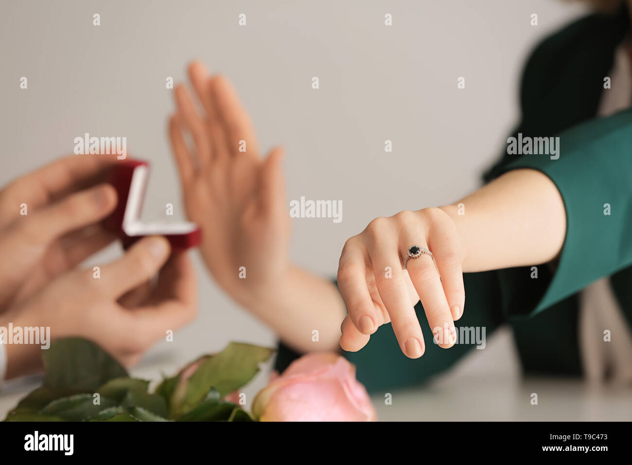 Young woman rejecting marriage proposal because she is already engaged ...