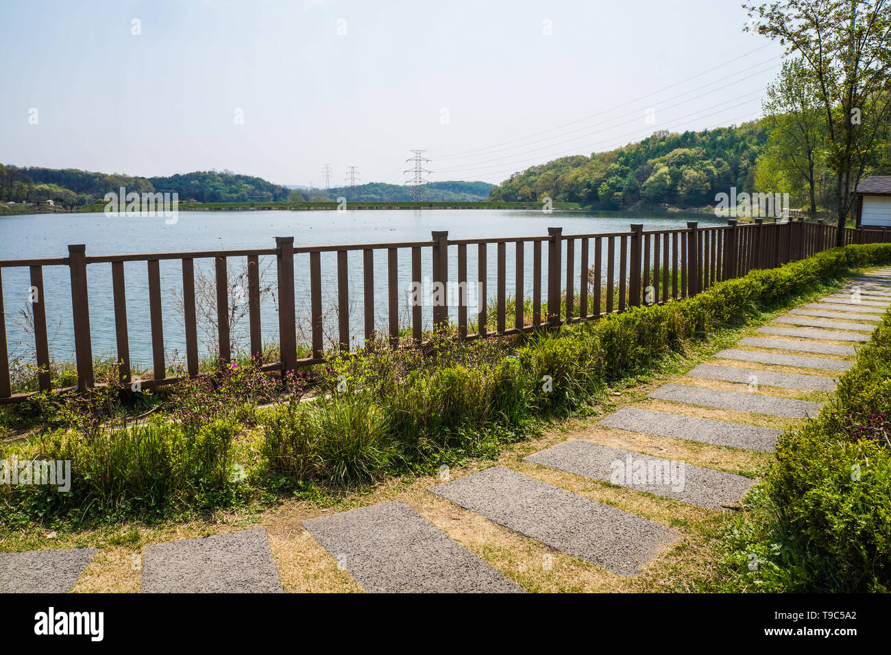 a stone-floor walkway by the lake Stock Photo - Alamy