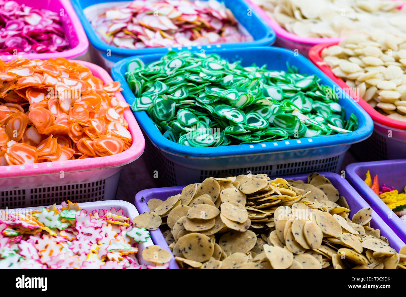 Colorful variety of fryums ready to fry snacks in an indian market ...