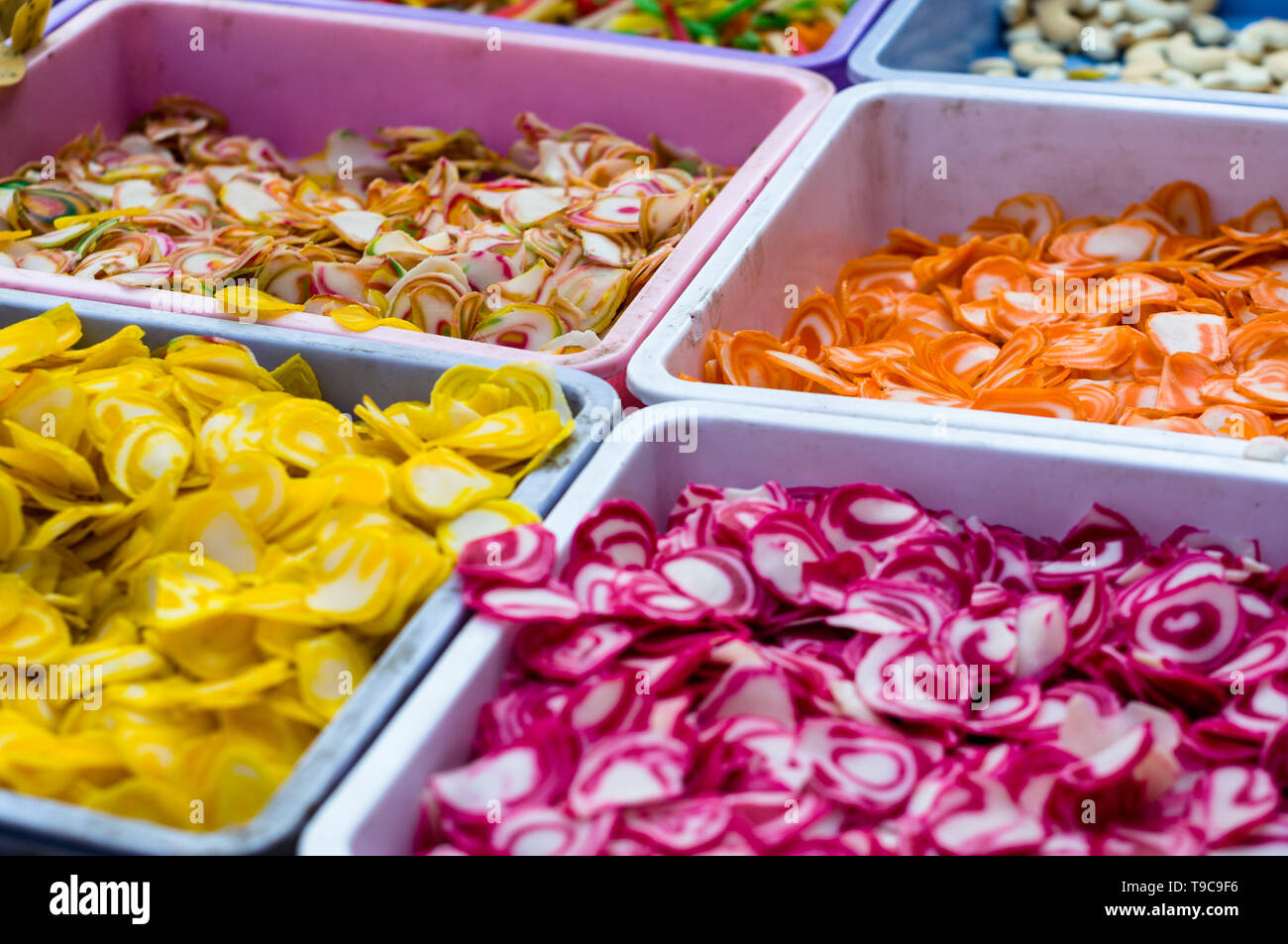 Colorful variety of fryums ready to fry snacks in an indian market ...