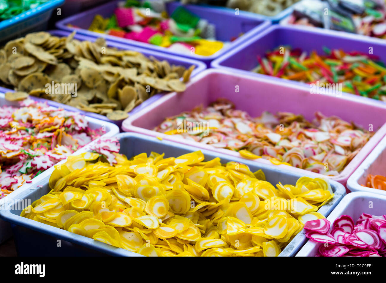 Colorful variety of fryums ready to fry snacks in an indian market ...