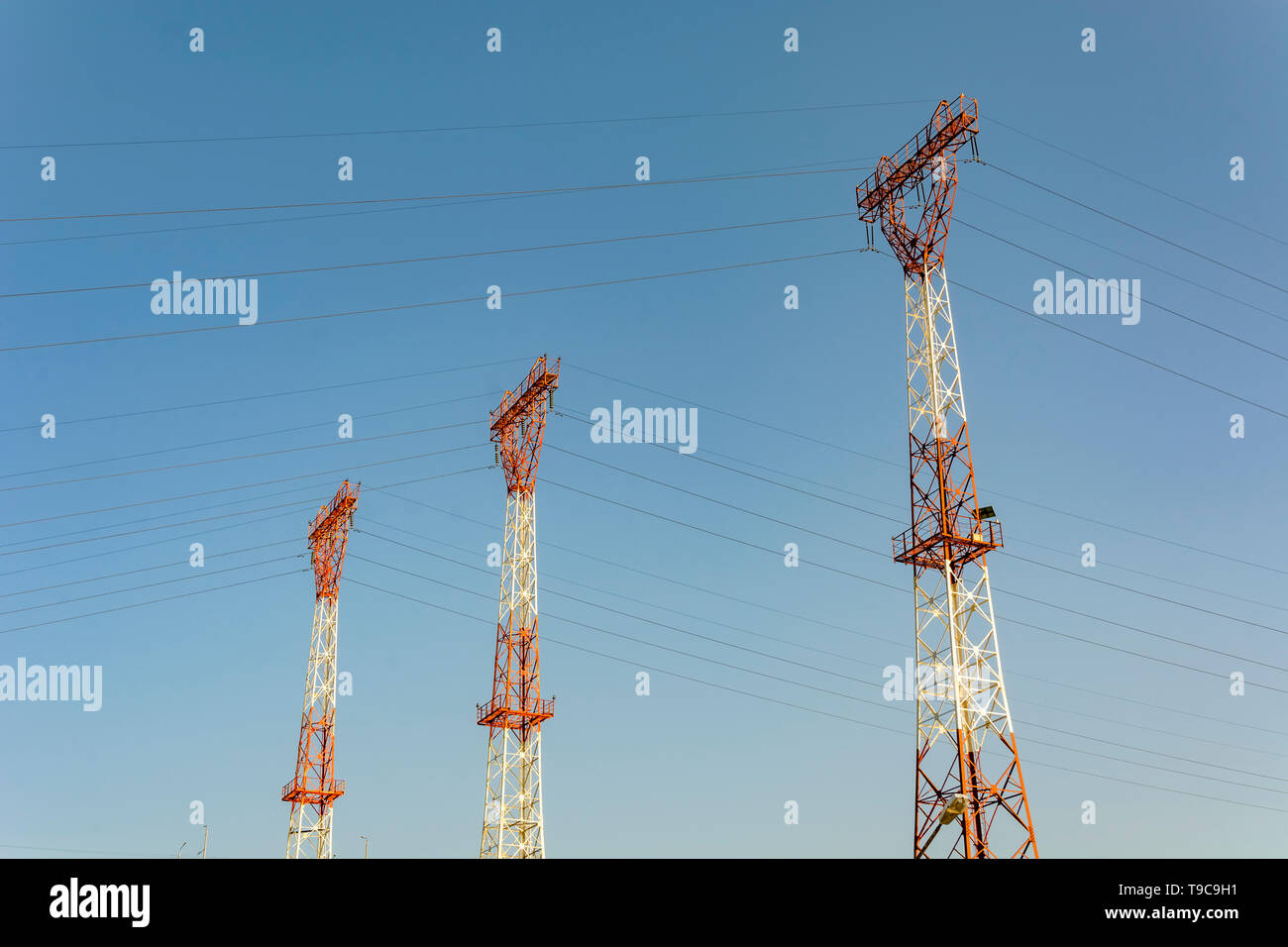 three power line with white and red color against blue sky Stock Photo ...
