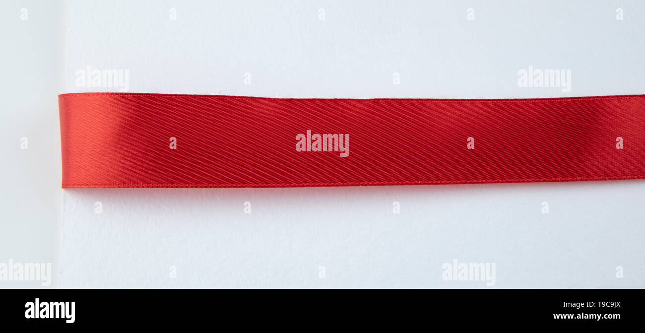 Shiny red ribbon on white background with copy space Stock Photo - Alamy