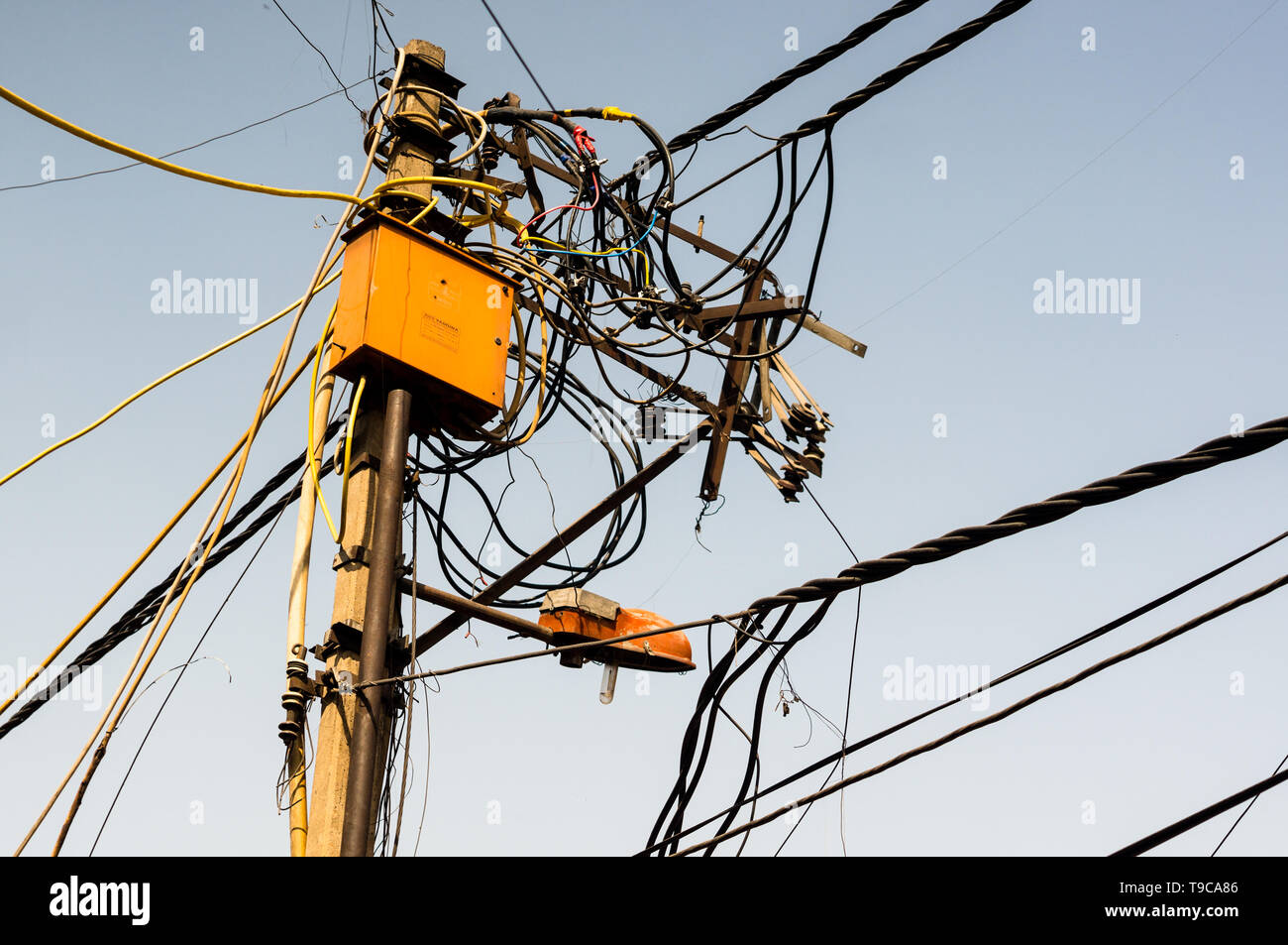 Tangled messy electrical wires on pole posing a safety hazard Stock ...