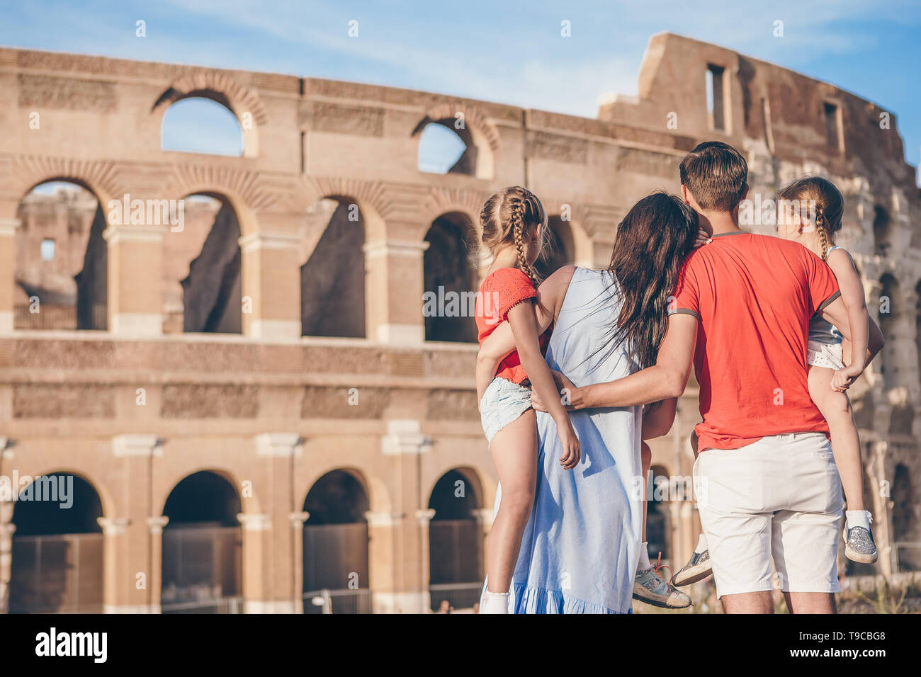 Happy family in Rome over Coliseum background Stock Photo - Alamy