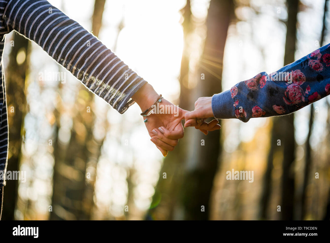 Blurred view two friends holding hi-res stock photography and images ...