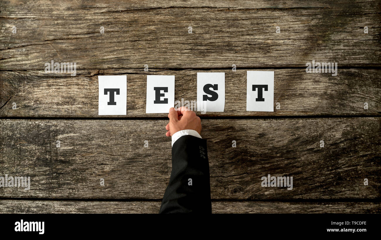 Top view of male hand assembling the Word Test with white cards over ...