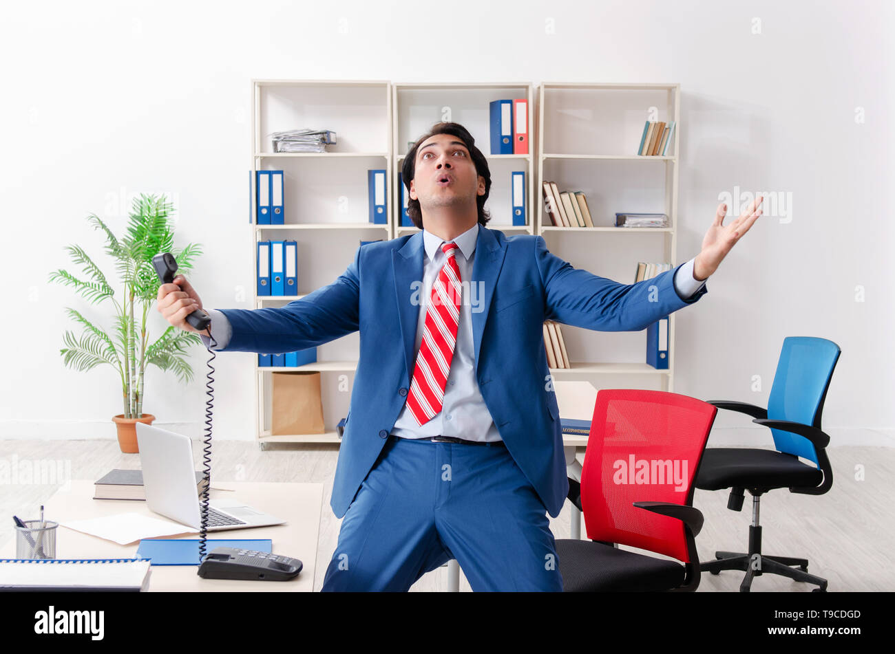 Young happy male employee in the office Stock Photo - Alamy