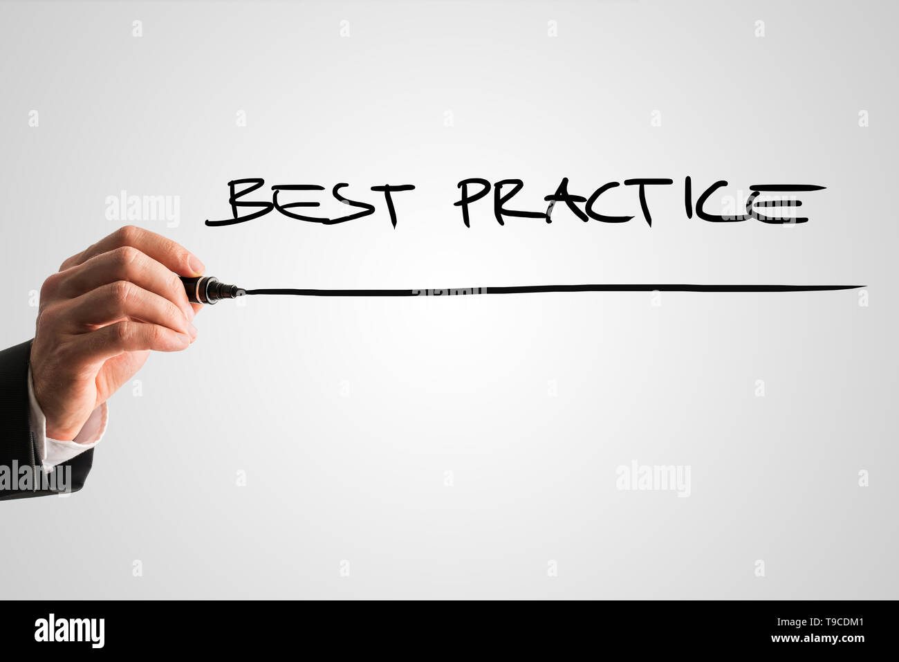 Hand of a man writing Best practice on a virtual screen with a marker ...