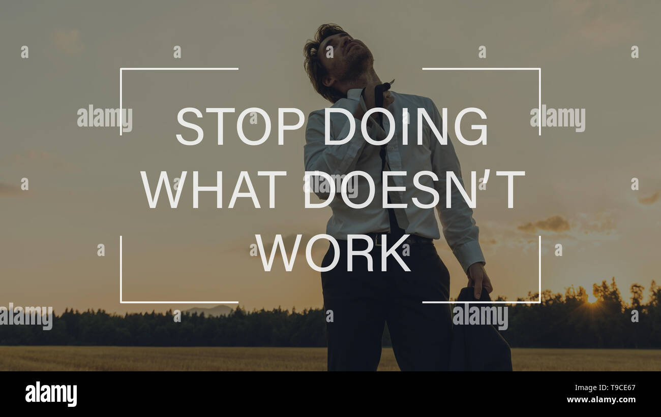 Stop doing what doesnt work sign over an exhausted businessman standing ...