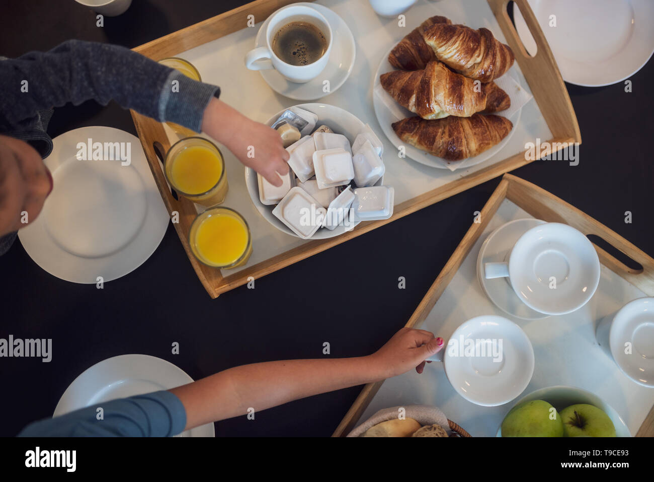 Top view of breakfast being served in a hotel with kids reaching for ...