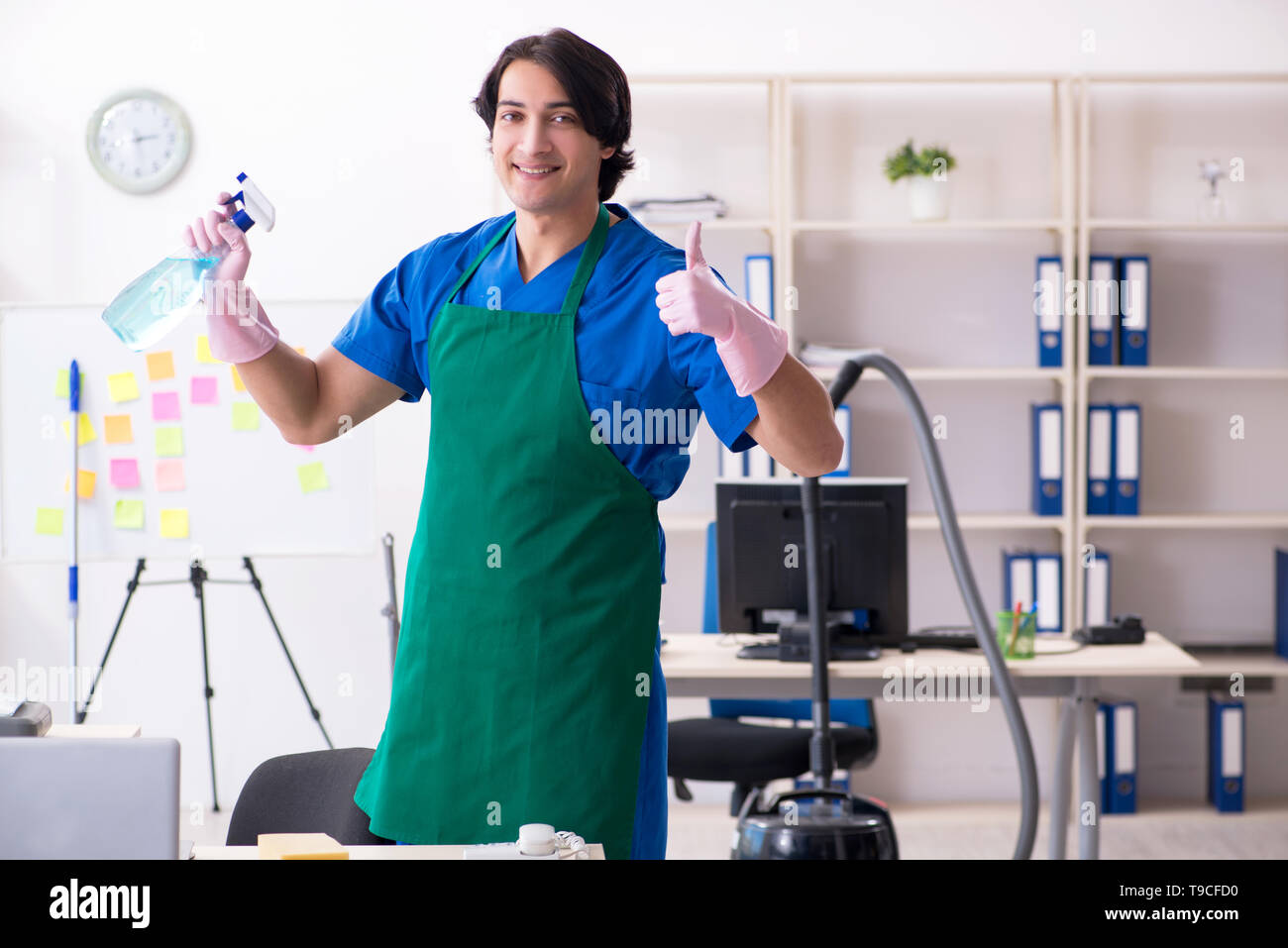 Male handsome professional cleaner working in the office Stock Photo ...
