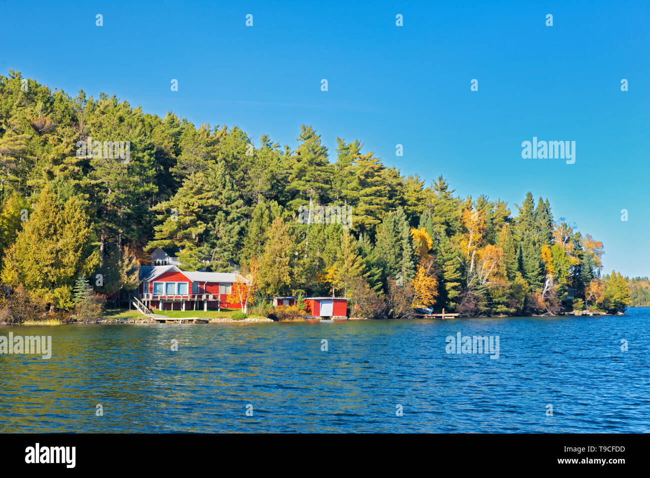 Dock and cottages and Autumn on Crow Lake (also known as Kakagi Lake ...