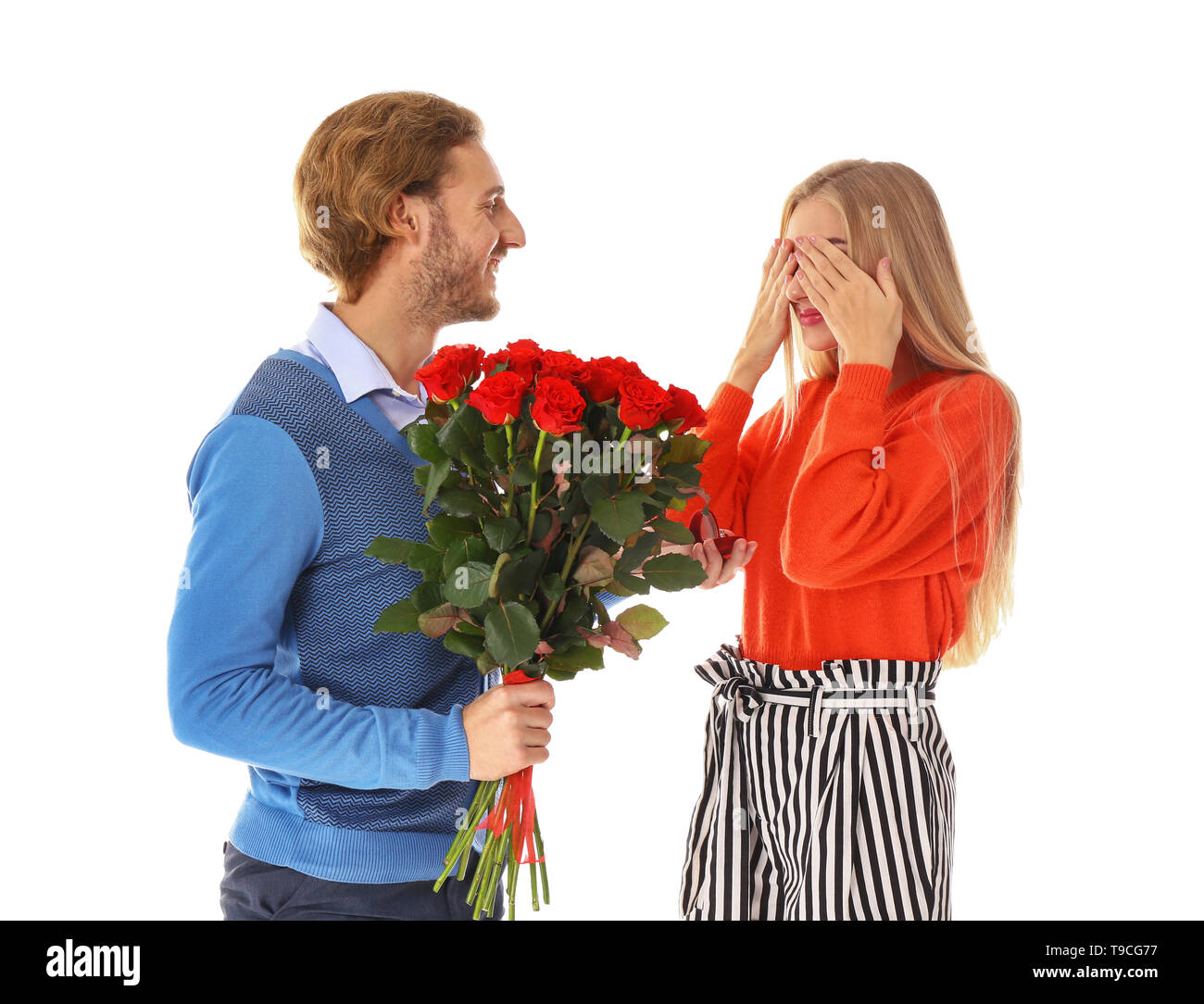 Young man proposing to his beloved on white background Stock Photo - Alamy