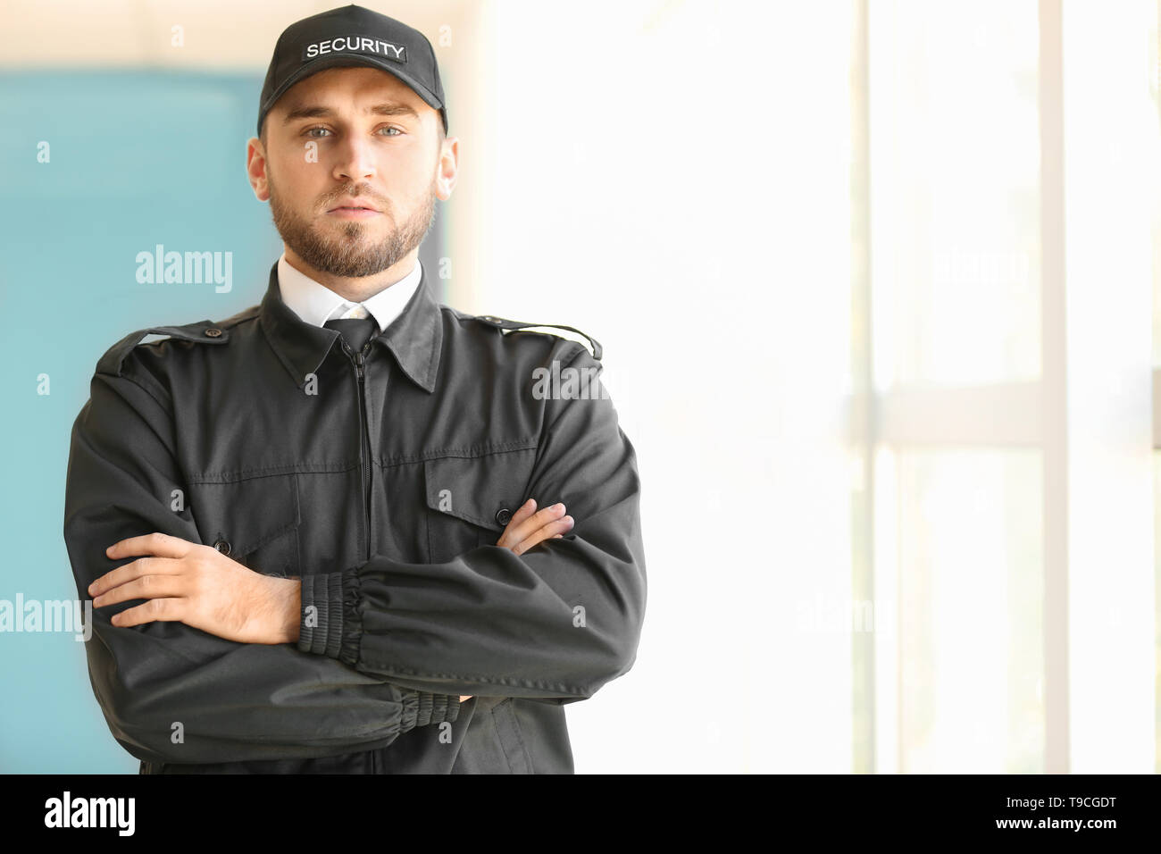 Male security guard indoors Stock Photo - Alamy