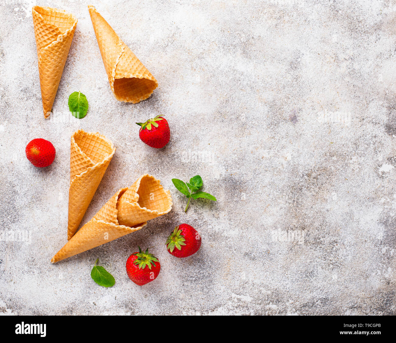 Empty waffle cones for ice cream and strawberry Stock Photo - Alamy